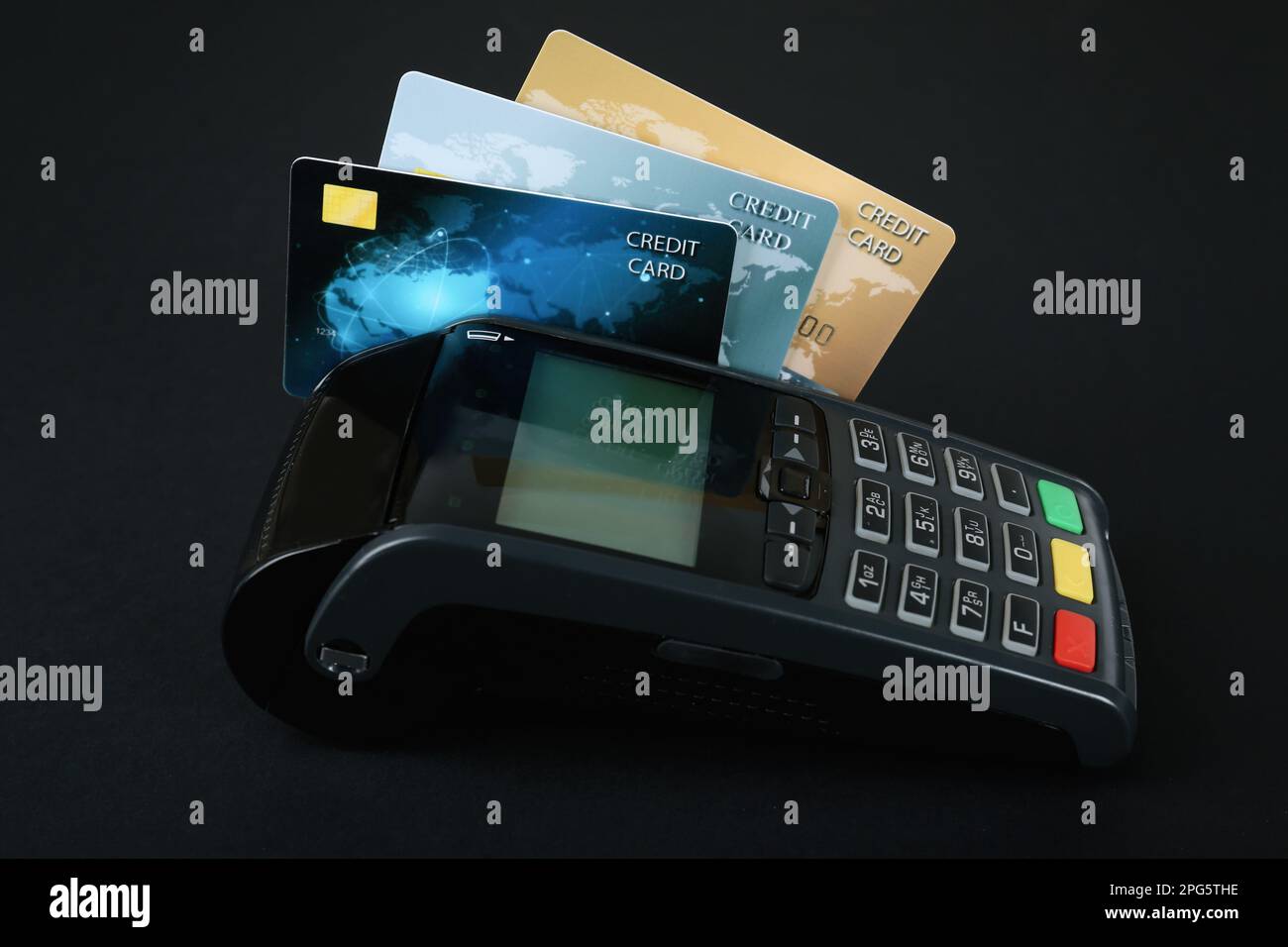 New modern payment terminal with credit cards on black background Stock ...