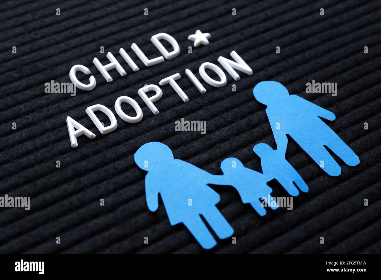 Family figure and phrase Child Adoption on black letter board Stock ...
