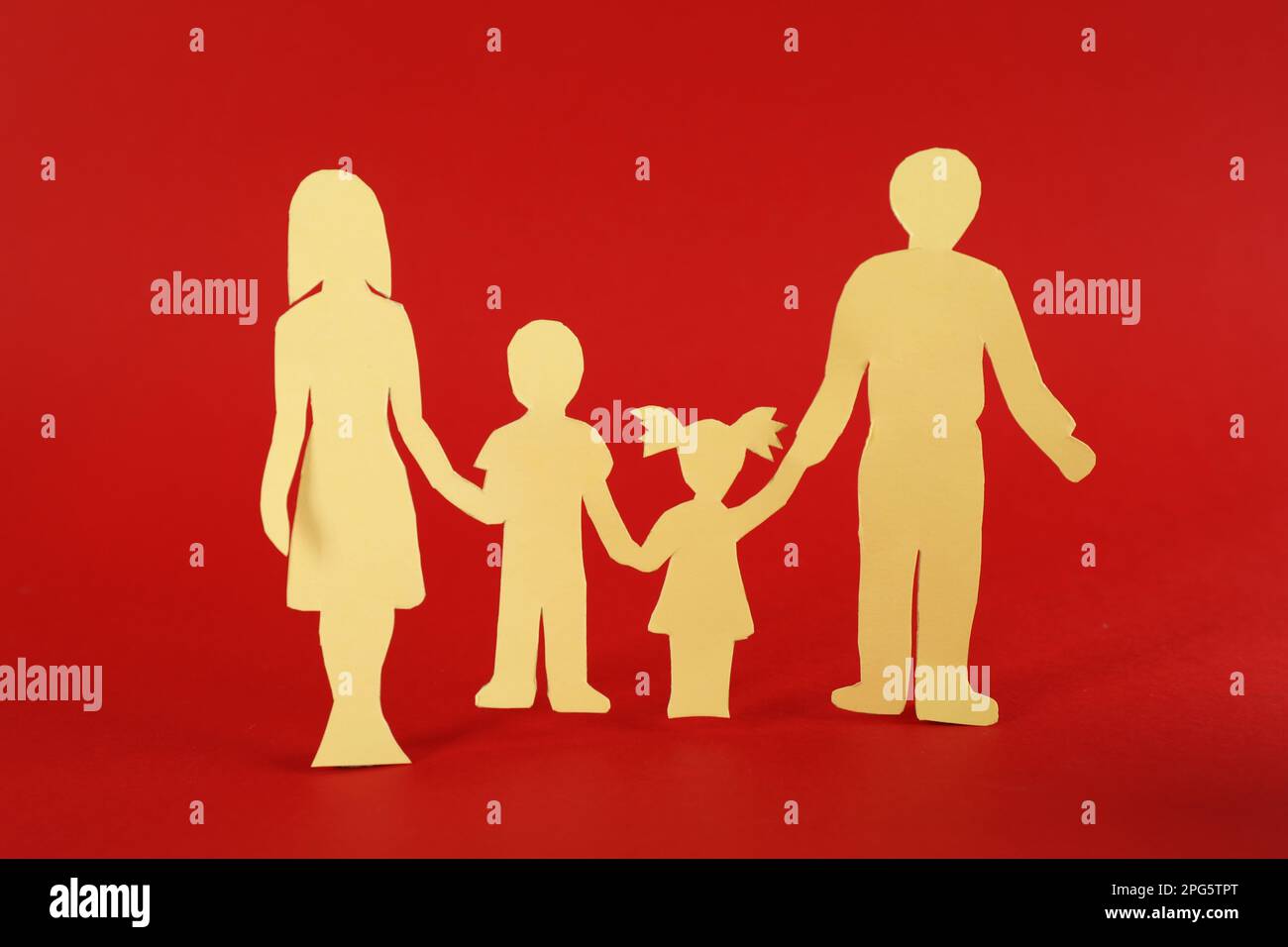 Paper family figure on red background. Child adoption concept Stock ...