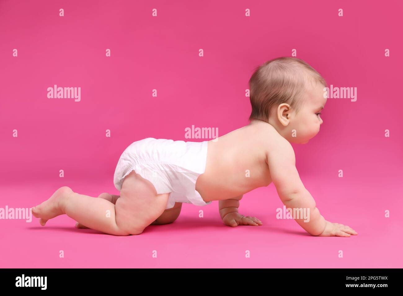 Cute little baby in diaper crawling on pink background Stock Photo - Alamy
