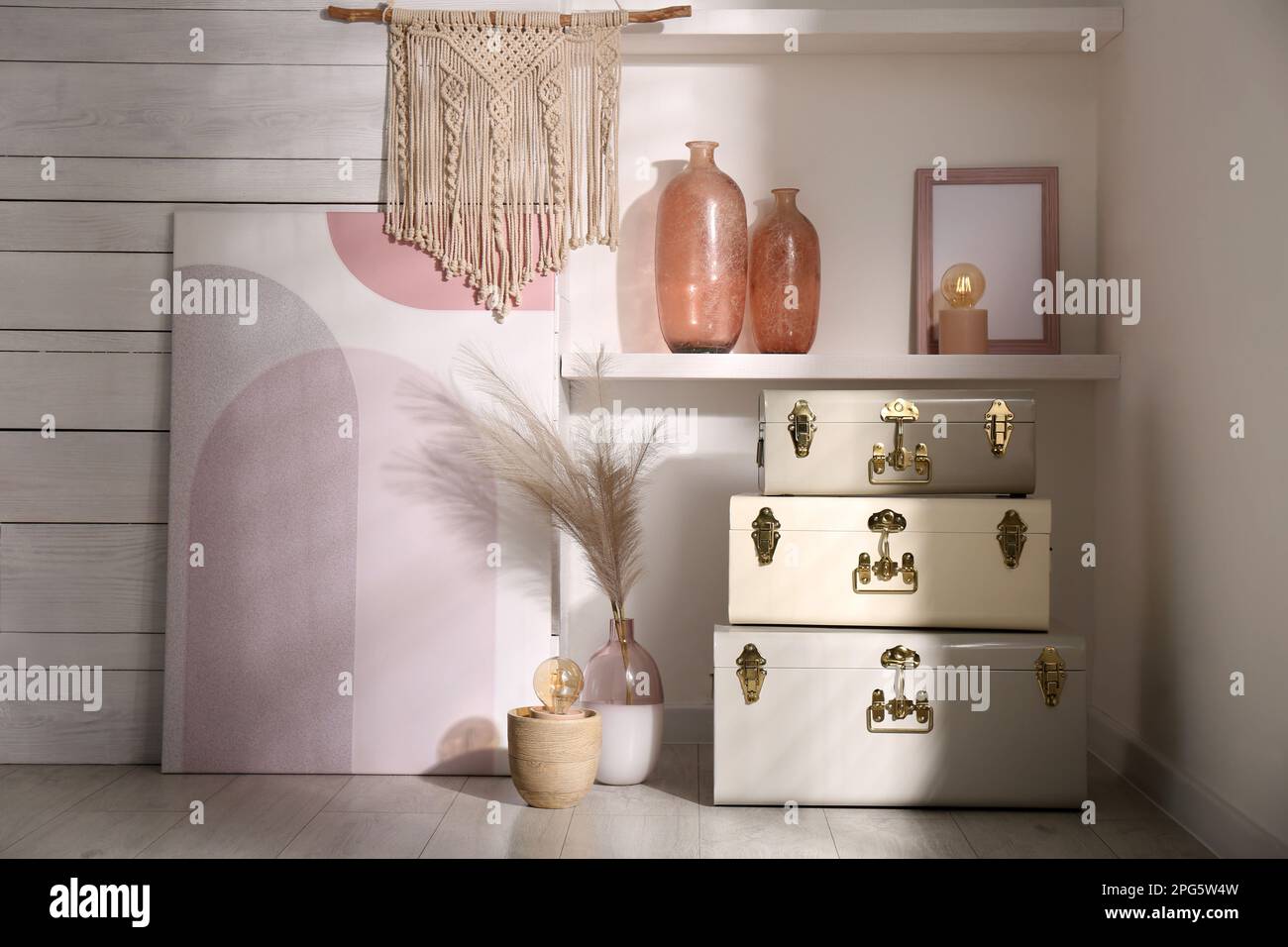 Stylish storage trunks and different decor elements near white wall ...