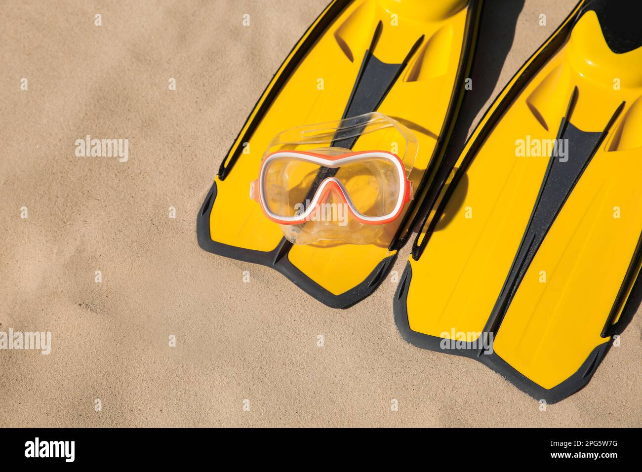 Pair of flippers and diving mask on sandy beach, above view Stock Photo ...
