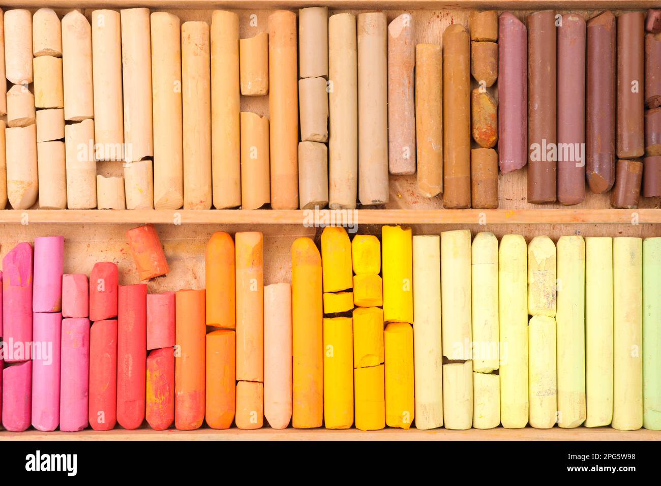 Set of soft pastels in wooden box as background, top view. Drawing ...