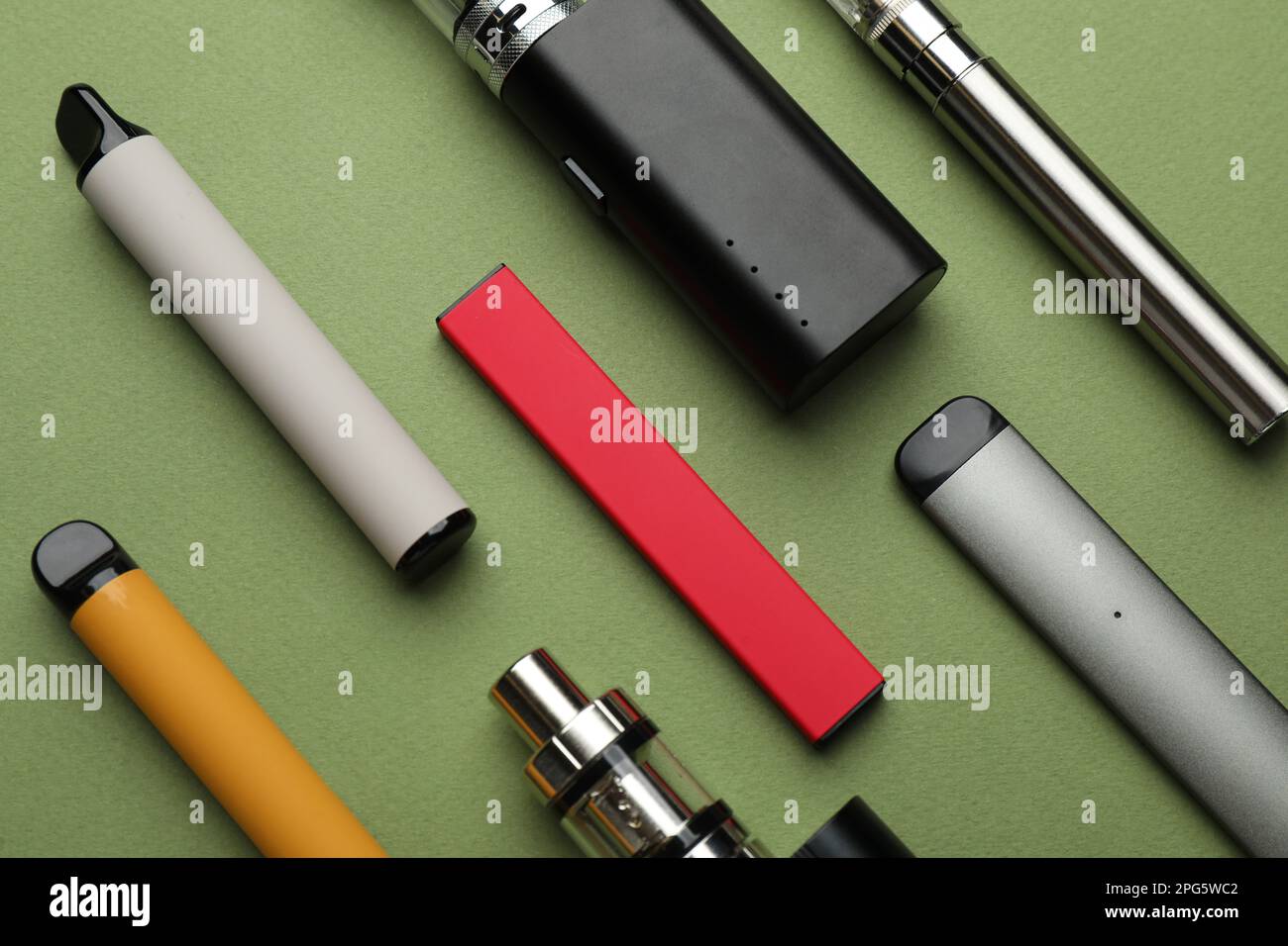 Many electronic smoking devices on olive background, flat lay Stock ...