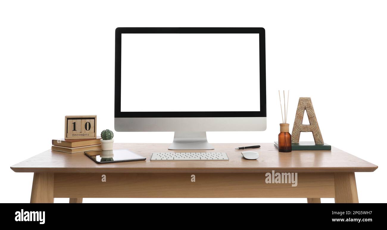 Wooden table with modern computer, decor and stationery on white ...