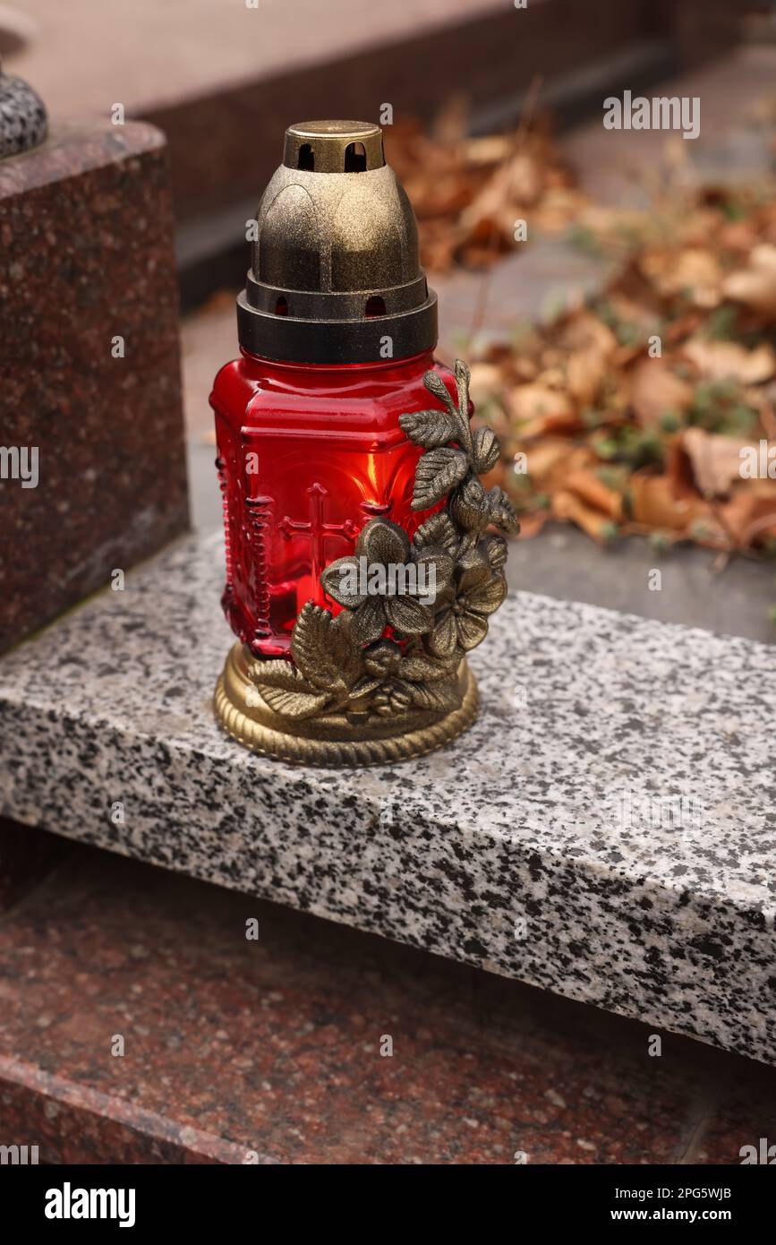 Grave lantern on grey granite surface at cemetery Stock Photo - Alamy