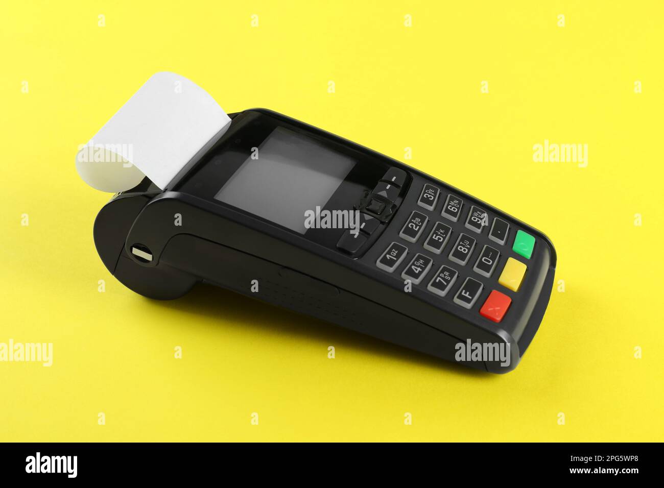 New modern payment terminal on yellow background Stock Photo - Alamy