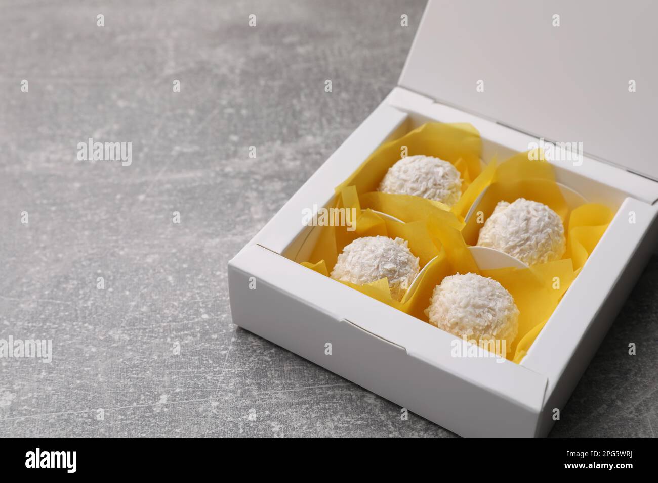 Delicious candies in box on light grey table, space for text Stock ...