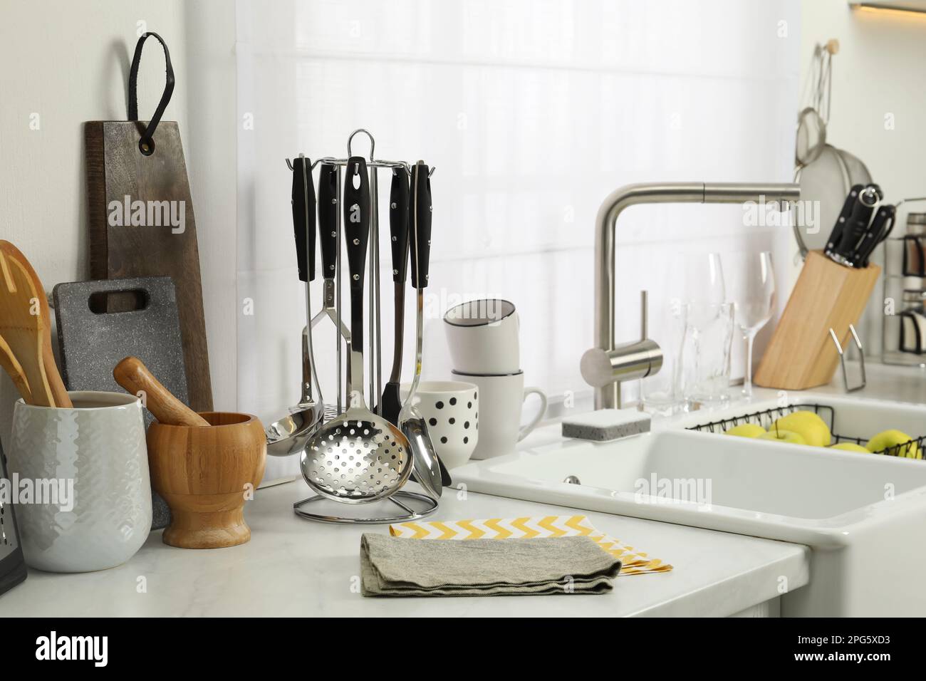 Countertop with sink and cooking utensils in kitchen Stock Photo - Alamy