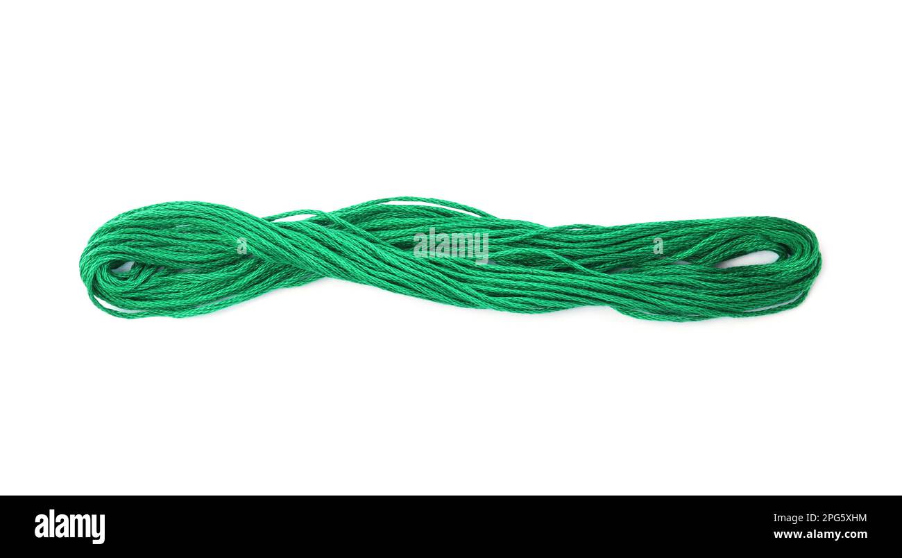 Bright green embroidery thread on white background Stock Photo - Alamy