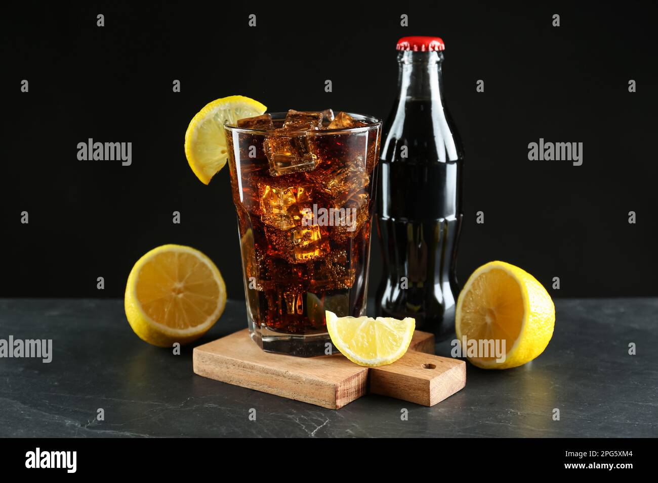 Bottle and glass of refreshing soda water on black table Stock Photo ...