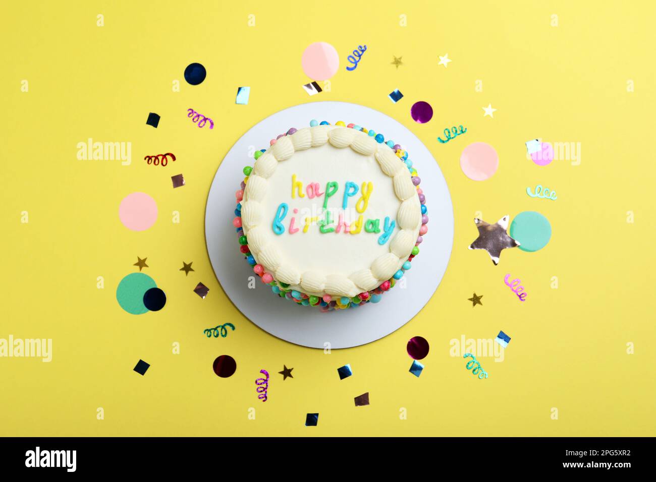 Cute bento cake with tasty cream and confetti on yellow background ...