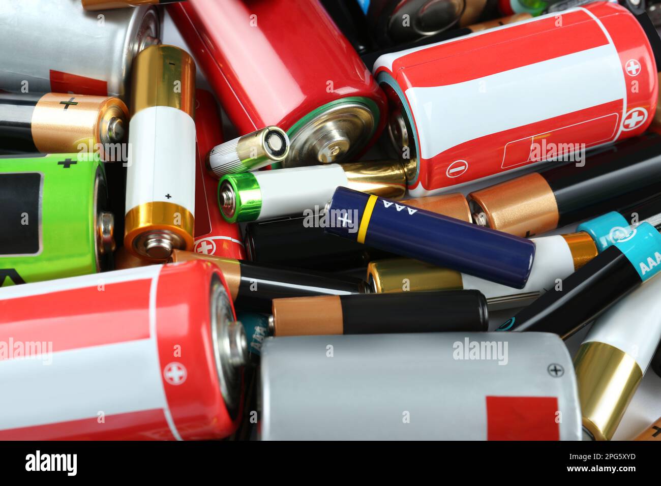 Many batteries of different types as background, closeup view Stock ...