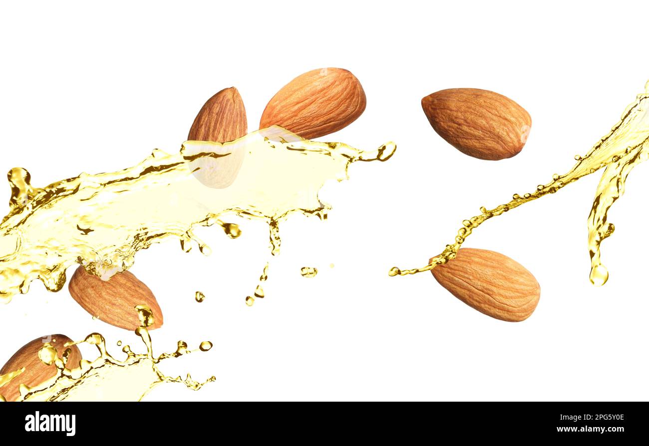 Organic almond oil and tasty nuts flying on white background Stock ...