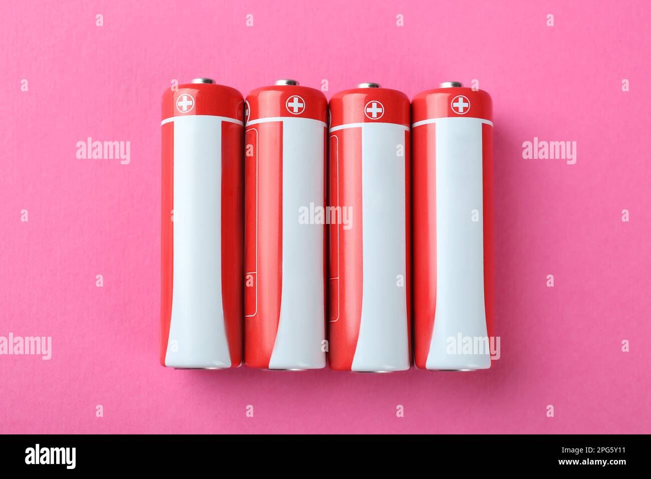 New AA batteries on pink background, flat lay Stock Photo - Alamy