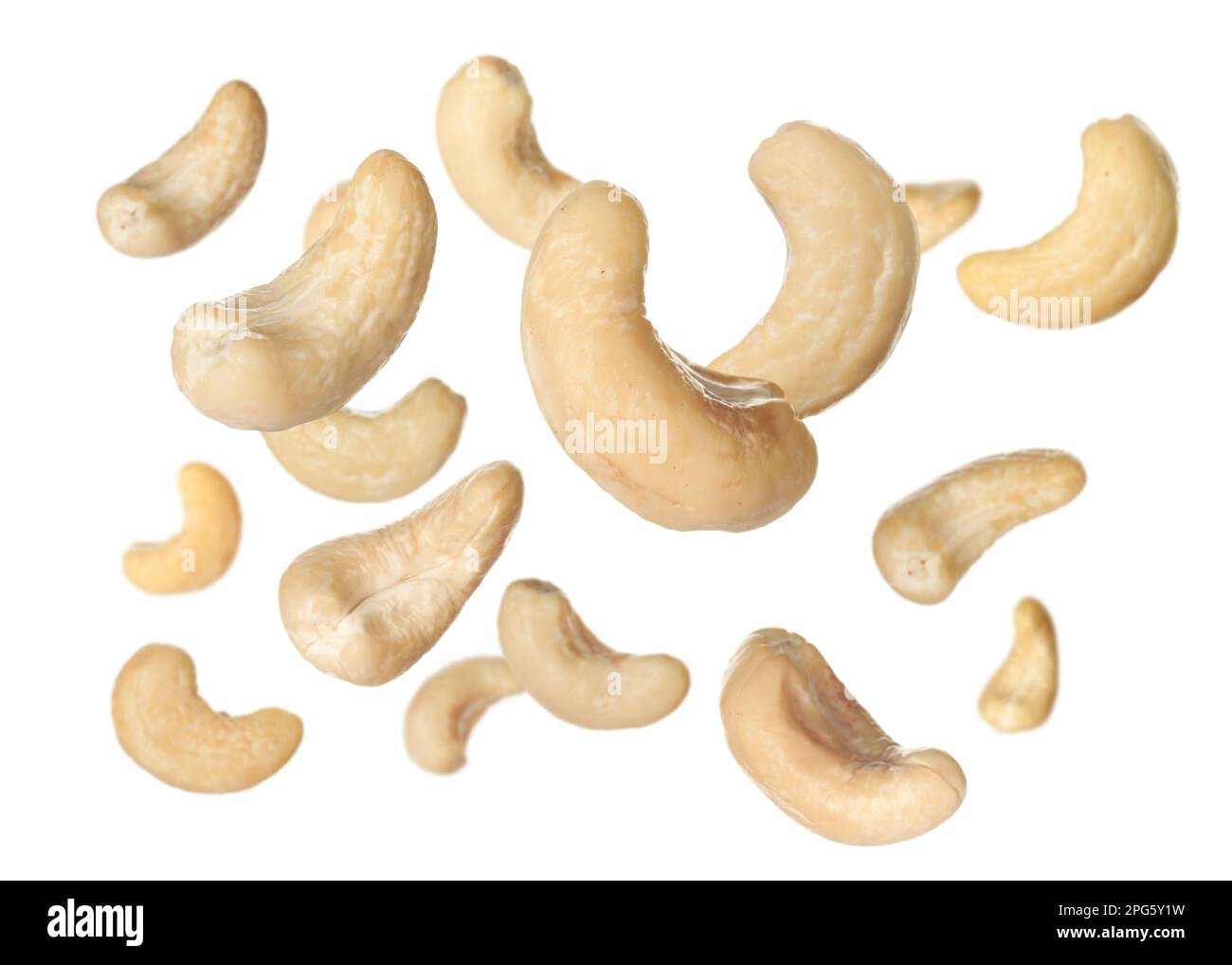 Tasty raw cashew nuts falling on white background Stock Photo - Alamy