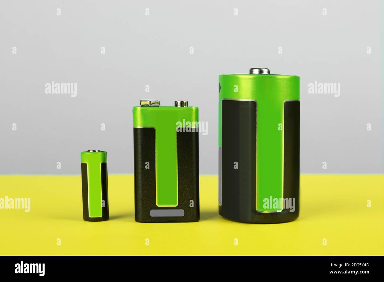 Different types of batteries on color background Stock Photo - Alamy