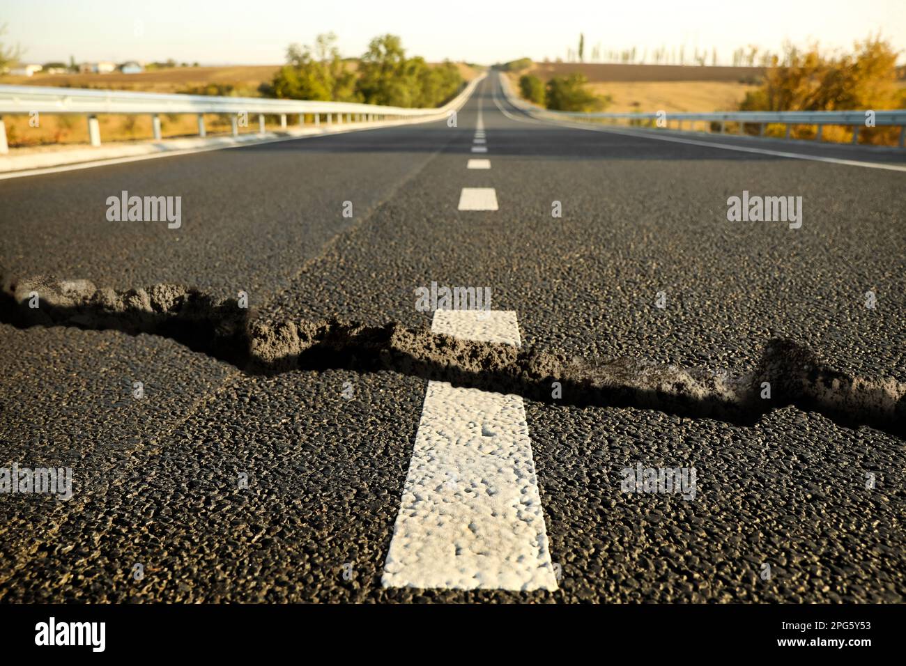 Large crack on asphalt road after earthquake Stock Photo - Alamy