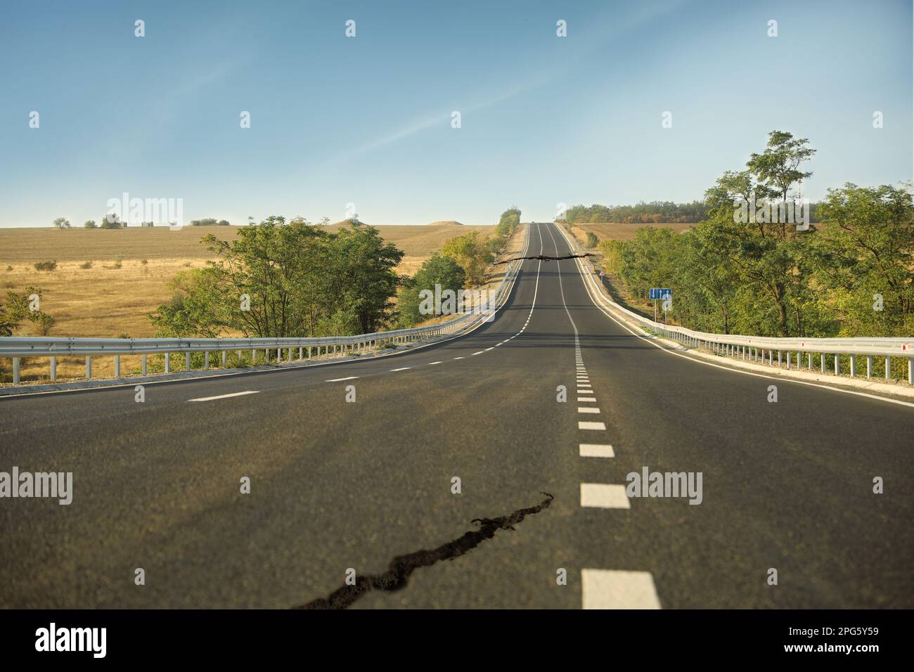 Large crack on asphalt road after earthquake Stock Photo - Alamy