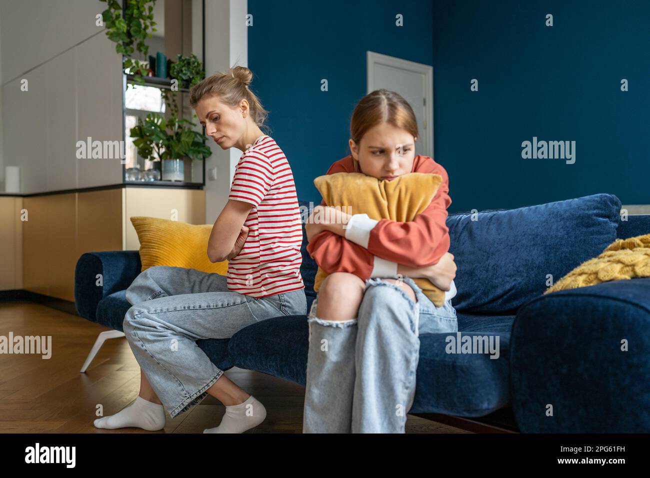 Upset frustrated mother and teenage daughter ignoring each other after quarrel at home, not ...