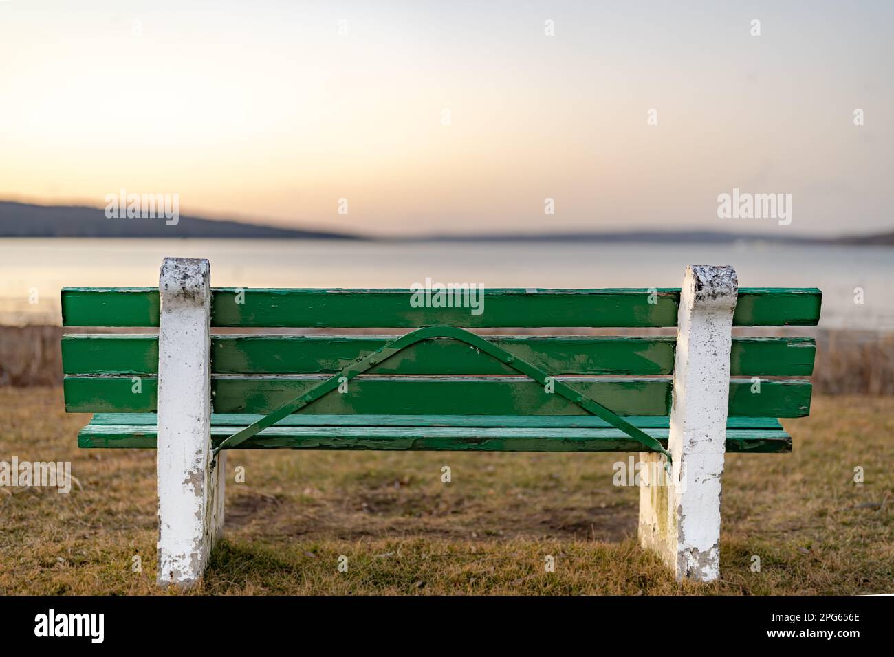 Green wood bench from behind with lake background Stock Photo - Alamy