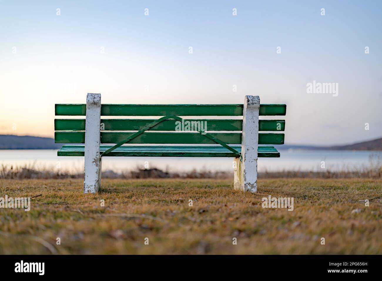 Green wood bench from behind with lake background Stock Photo - Alamy
