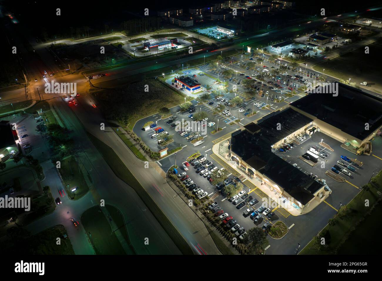 Aerial night view of many cars parked on parking lot with lines and ...