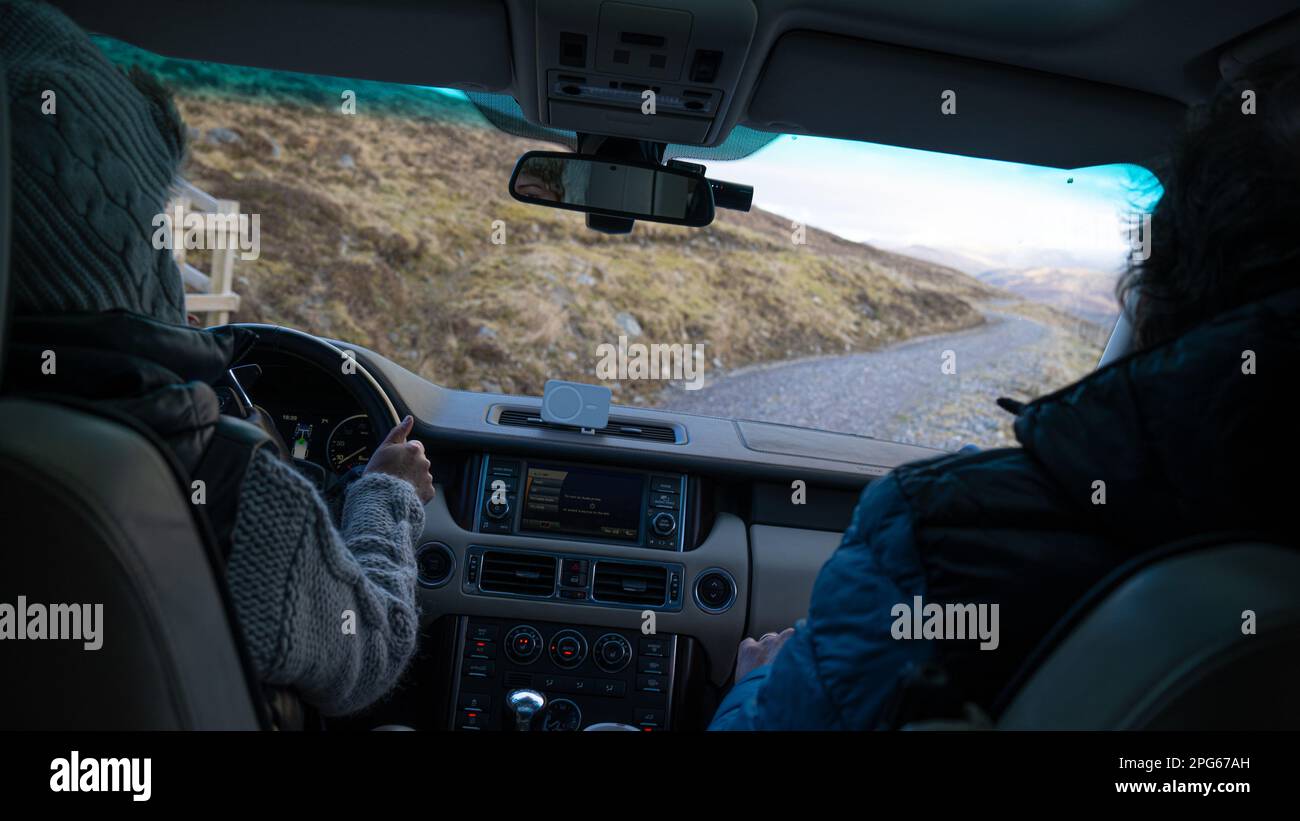 Woman driving in nature. Climbing the mountain peak with a 4x4 vehicle ...