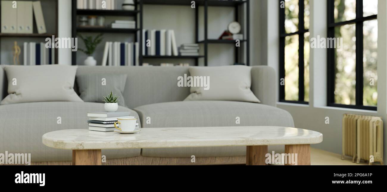 Cozy Scandinavian living room with beige sofa and bookshelf near large window, coffee table ...