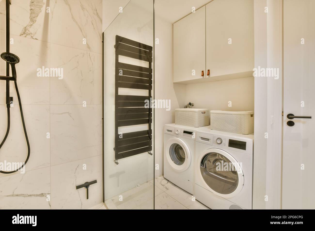 a laundry room with a washer, dryer and washing machine in the corner ...