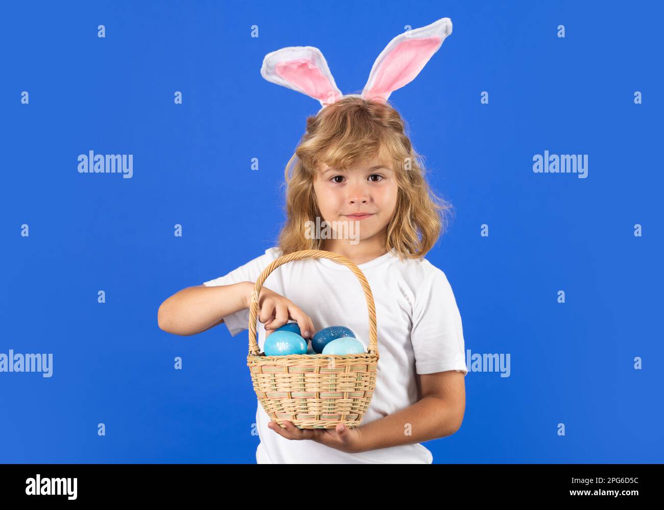 Easter to the child. Easter day. Child with rabbit ears holding easter ...
