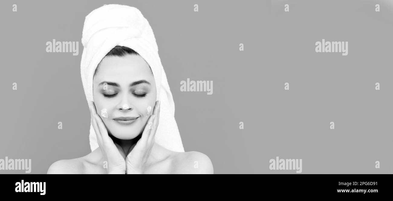 Skin care beauty woman. smiling young girl applying face cream on blue ...