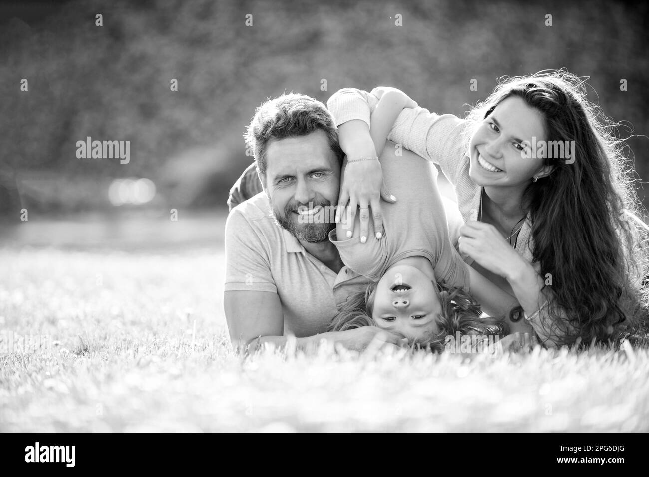 happy family of mom father and son child relax in summer park green ...