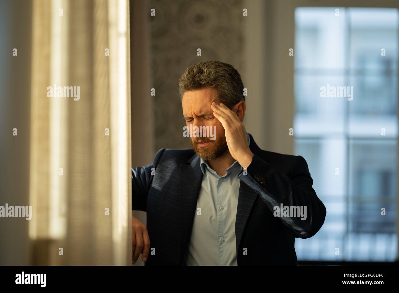 Man with sinus headache, tension or cluster headache, close up portrait ...
