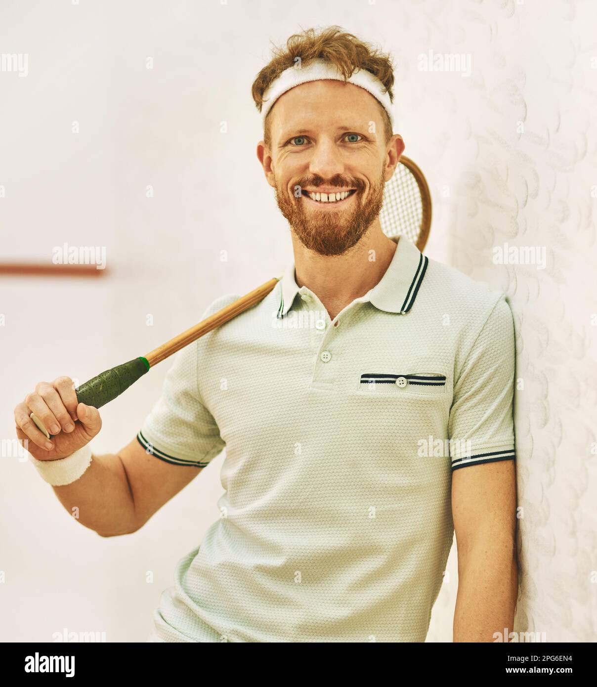 Meet the squash champion himself. a confident young man standing on a ...