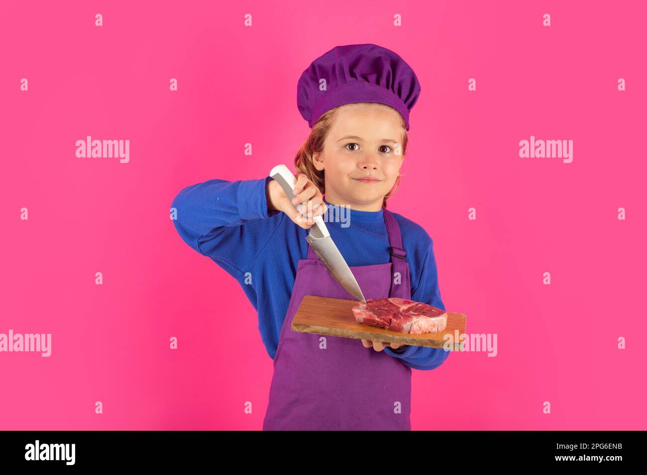 Child cook hold cutting board with meat beef steak and knife. Cooking ...