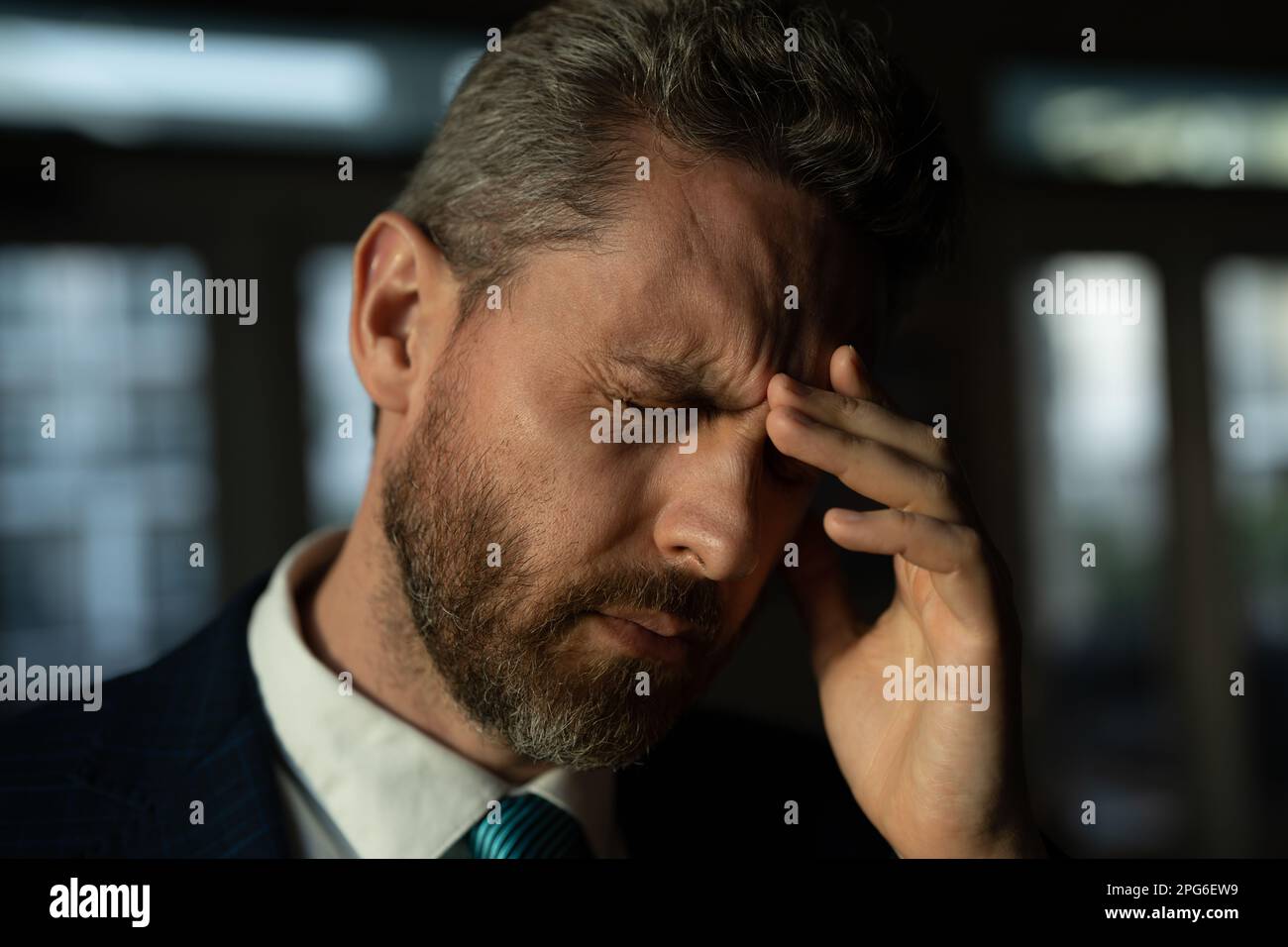 Tired man having a terrible headache. Exhausted man feeling unhealthy ...