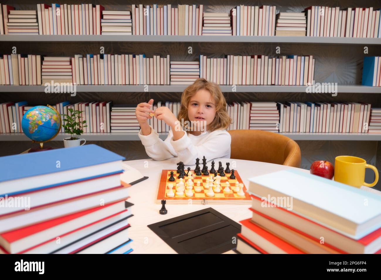 Chess school. Concentrated kid play chess. Smart child play chess in ...
