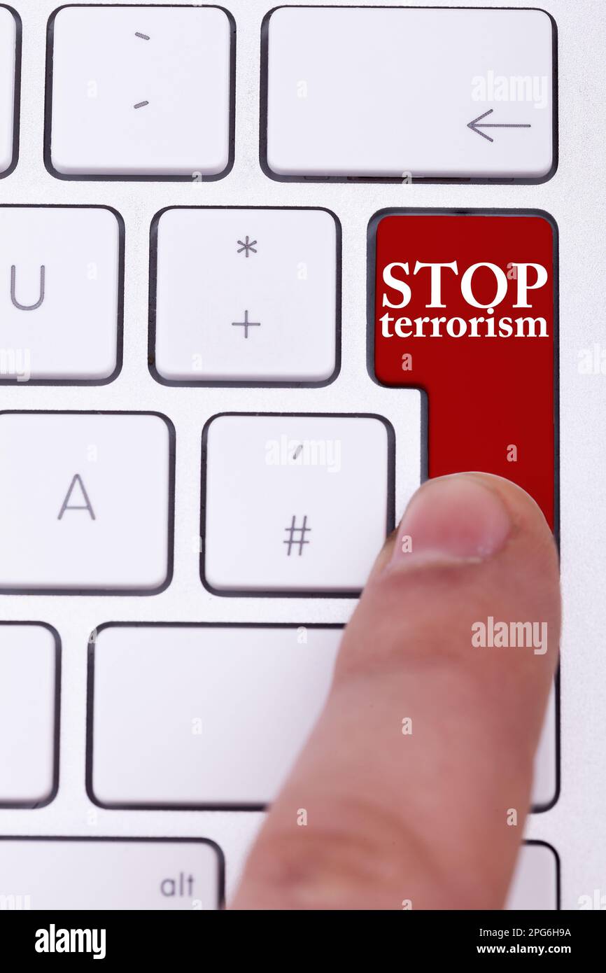 Finger pressing on stop terrorism button on keyboard. Stop the crimes ...
