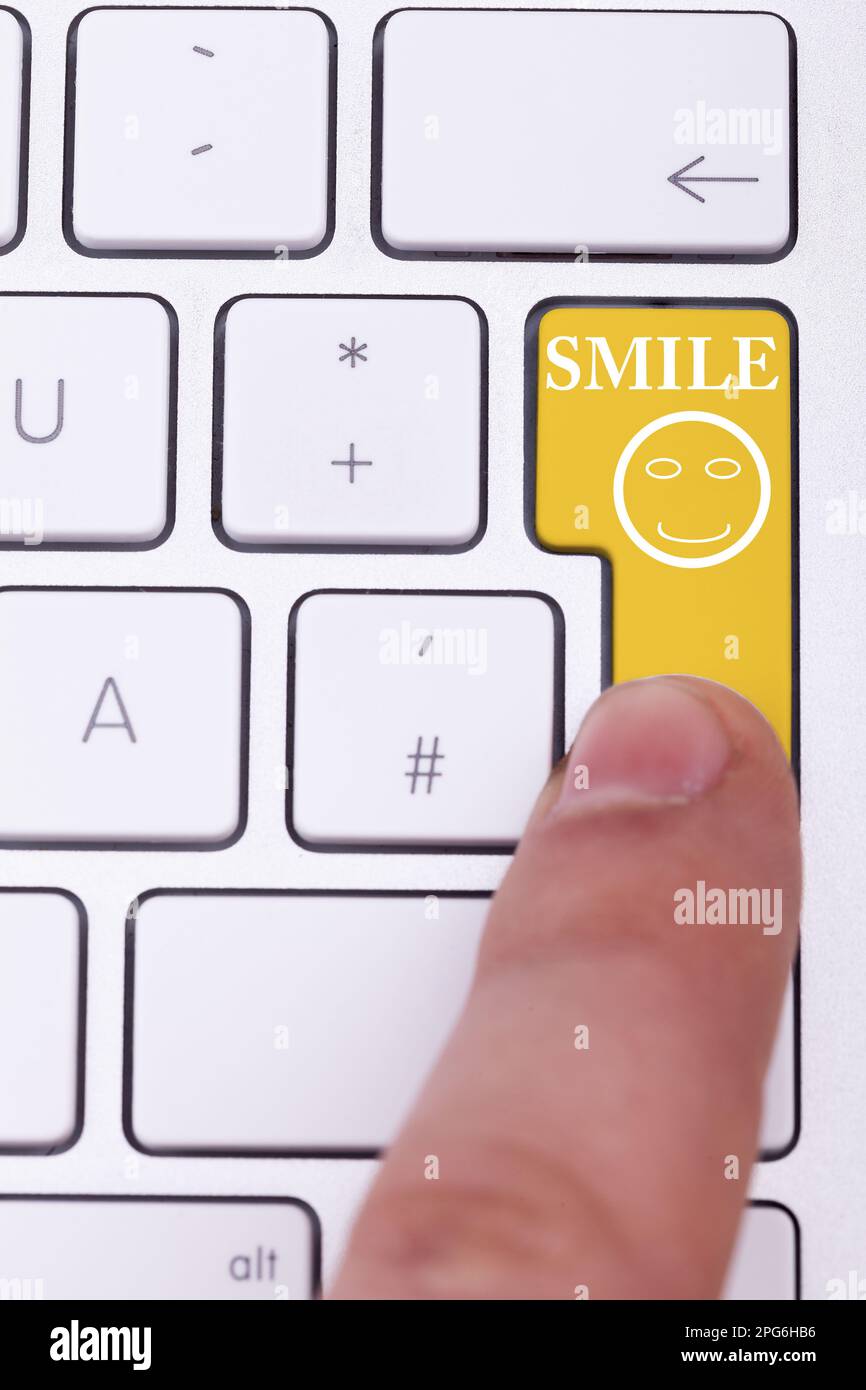 Finger pushing smile button on keyboard with a smile sign on it Stock ...
