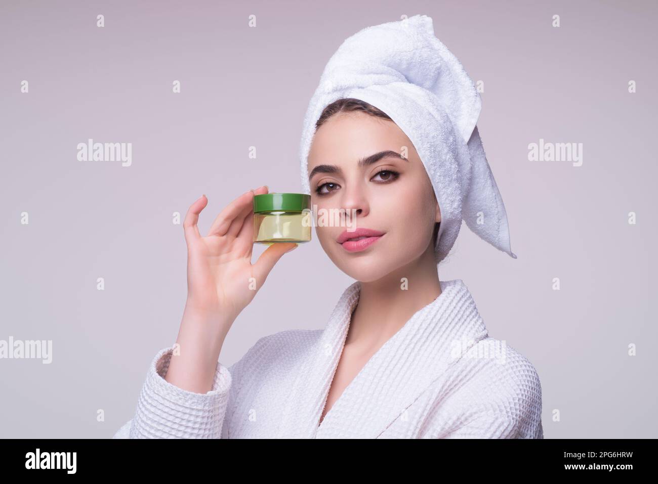 Beautiful woman applying moisturizer cream her face. Beauty concept. Skincare and pampering ...