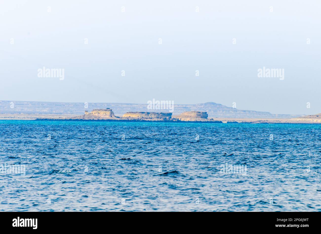 Sand dunes descending into the creek with limestone hills in the ...