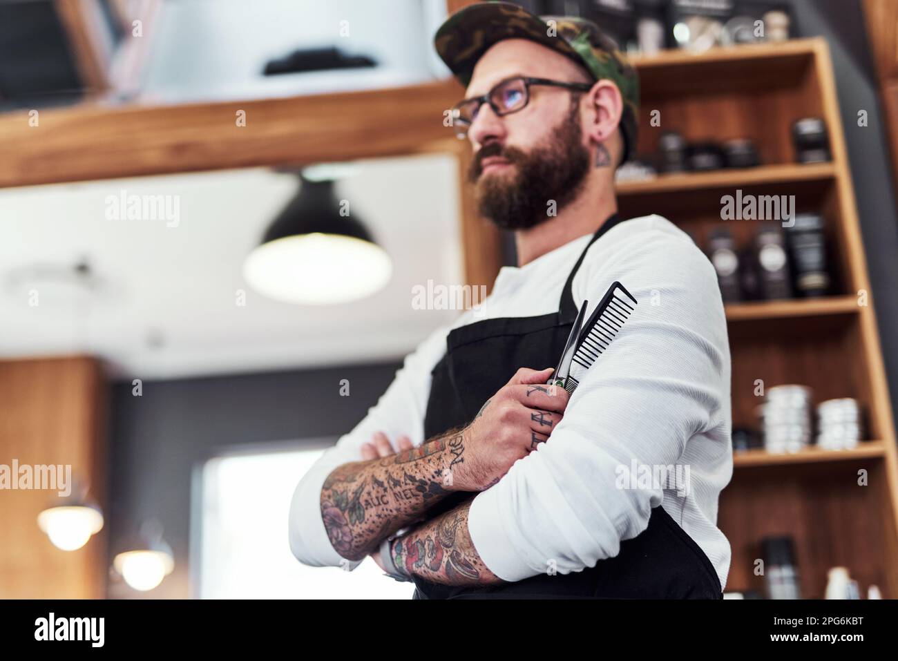 Armored up and ready to work. a handsome young barber posing with his ...
