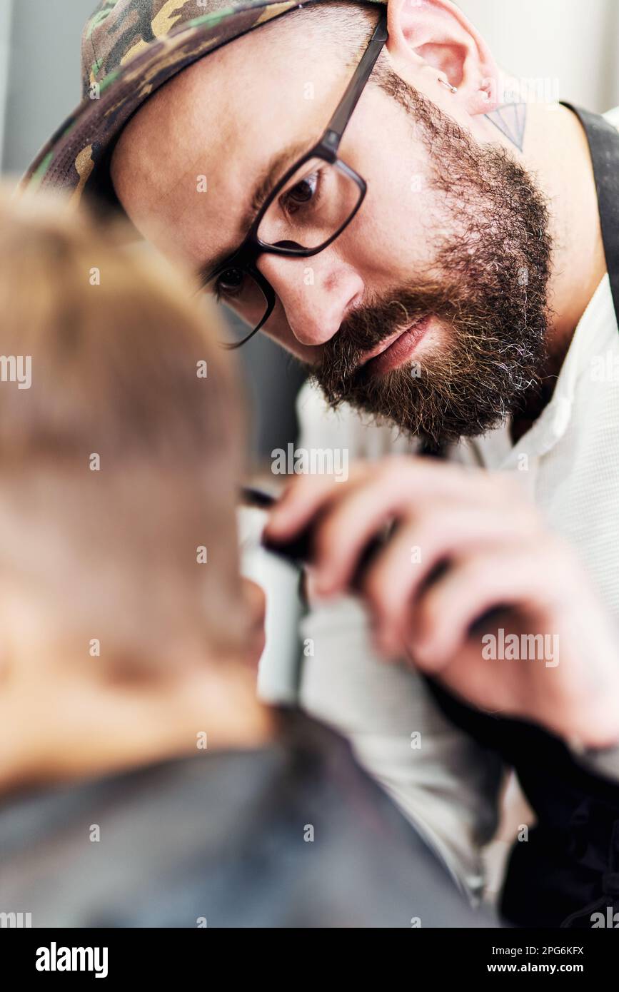 Hes always been a perfectionist. a handsome young barber giving a ...