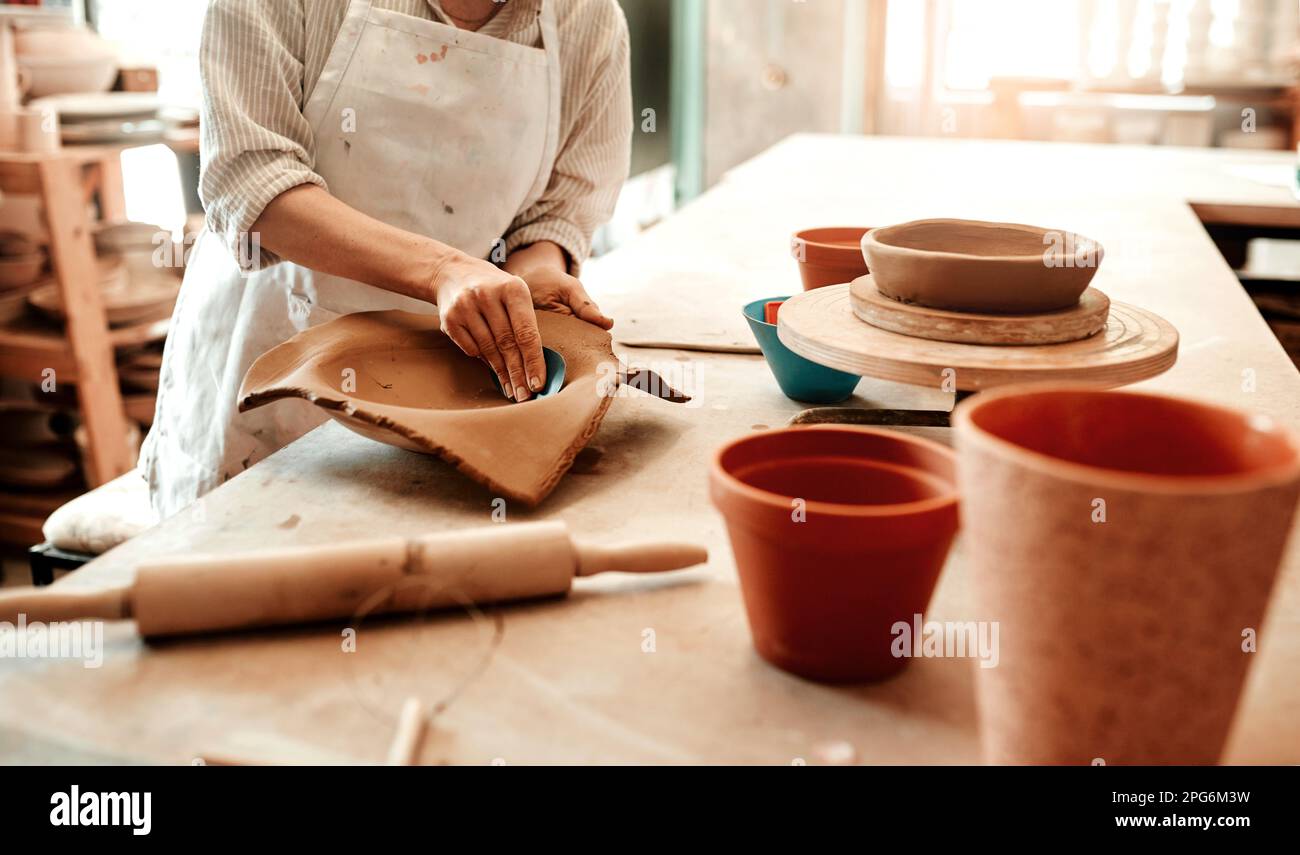 Live your dream. an unrecognizable artisan working in a pottery ...