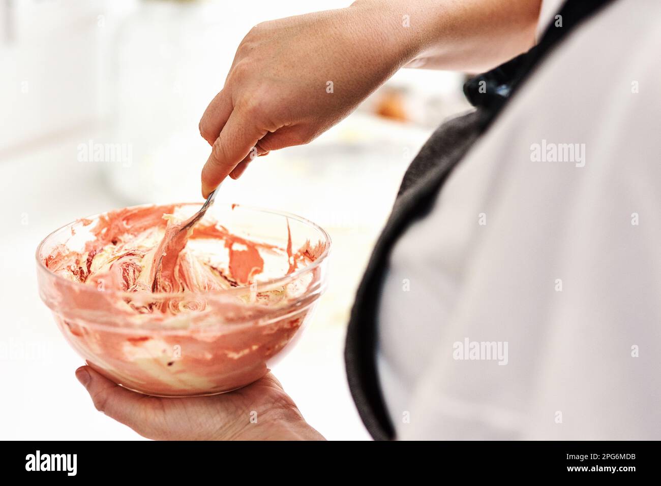 This will be the icing on the cake. an unrecognizable woman mixing ...