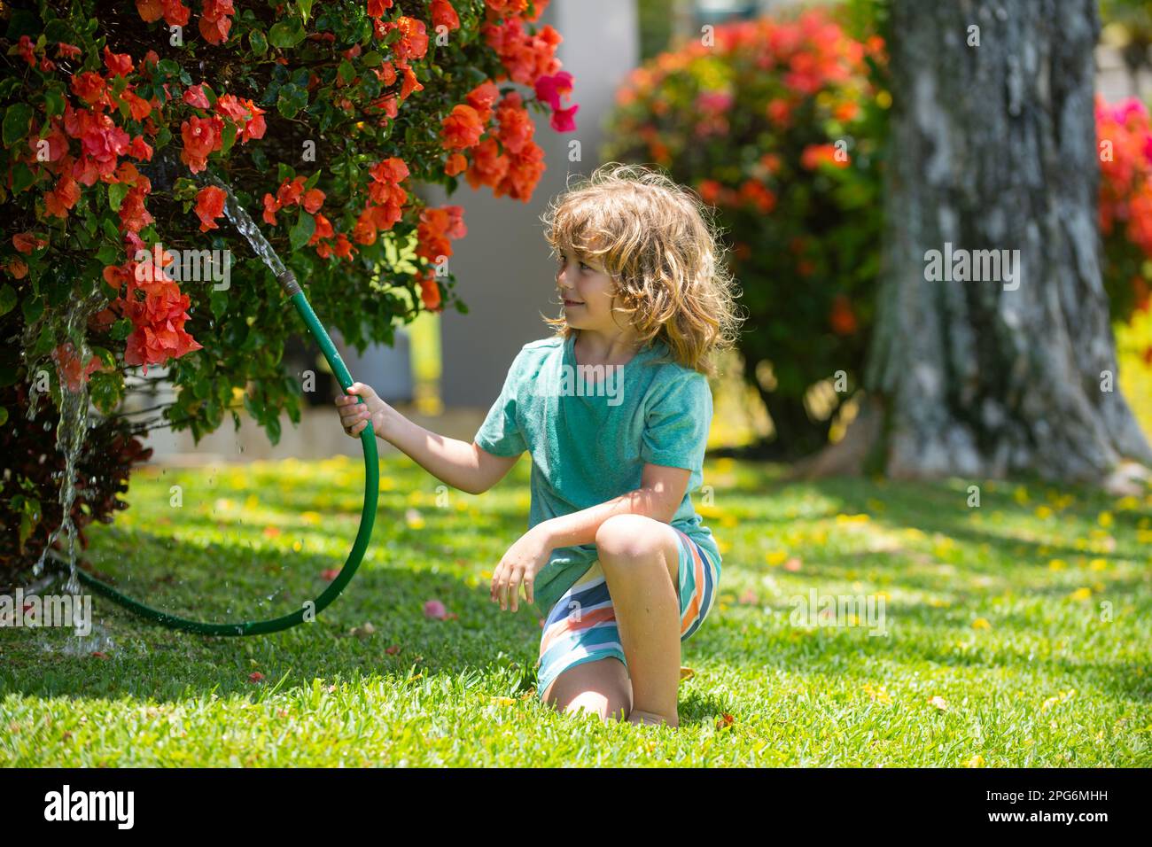 Kids play with water garden hose in yard. Outdoor children summer fun ...