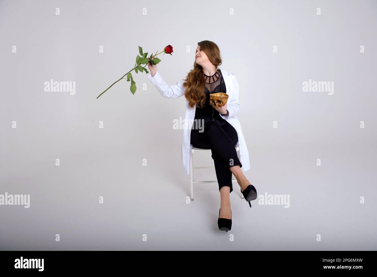 woman sitting on golden white chair smelling a rose Rose falling on the ...