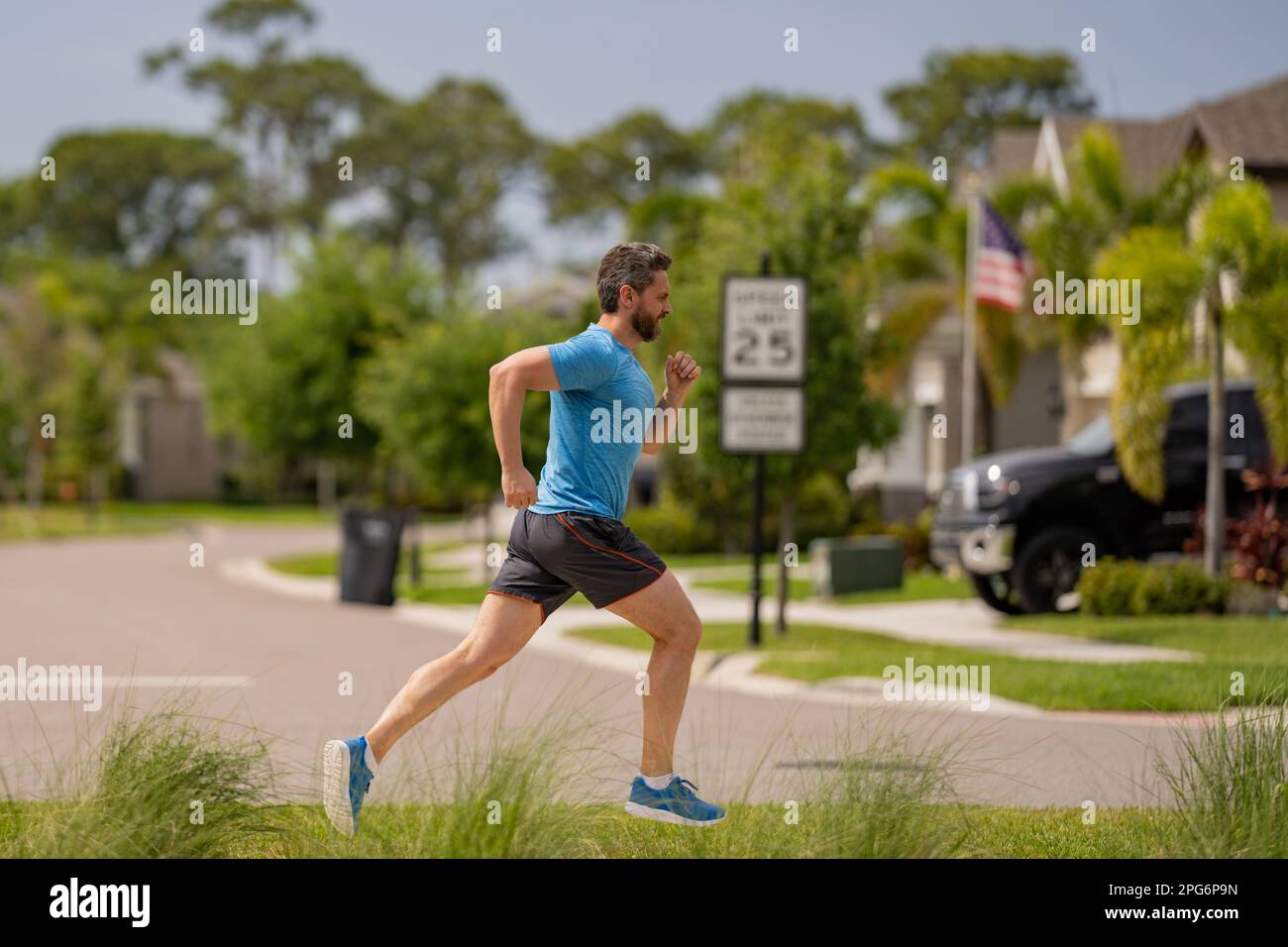 Fit man fitness model workout outdoor. Man runner on the street running ...