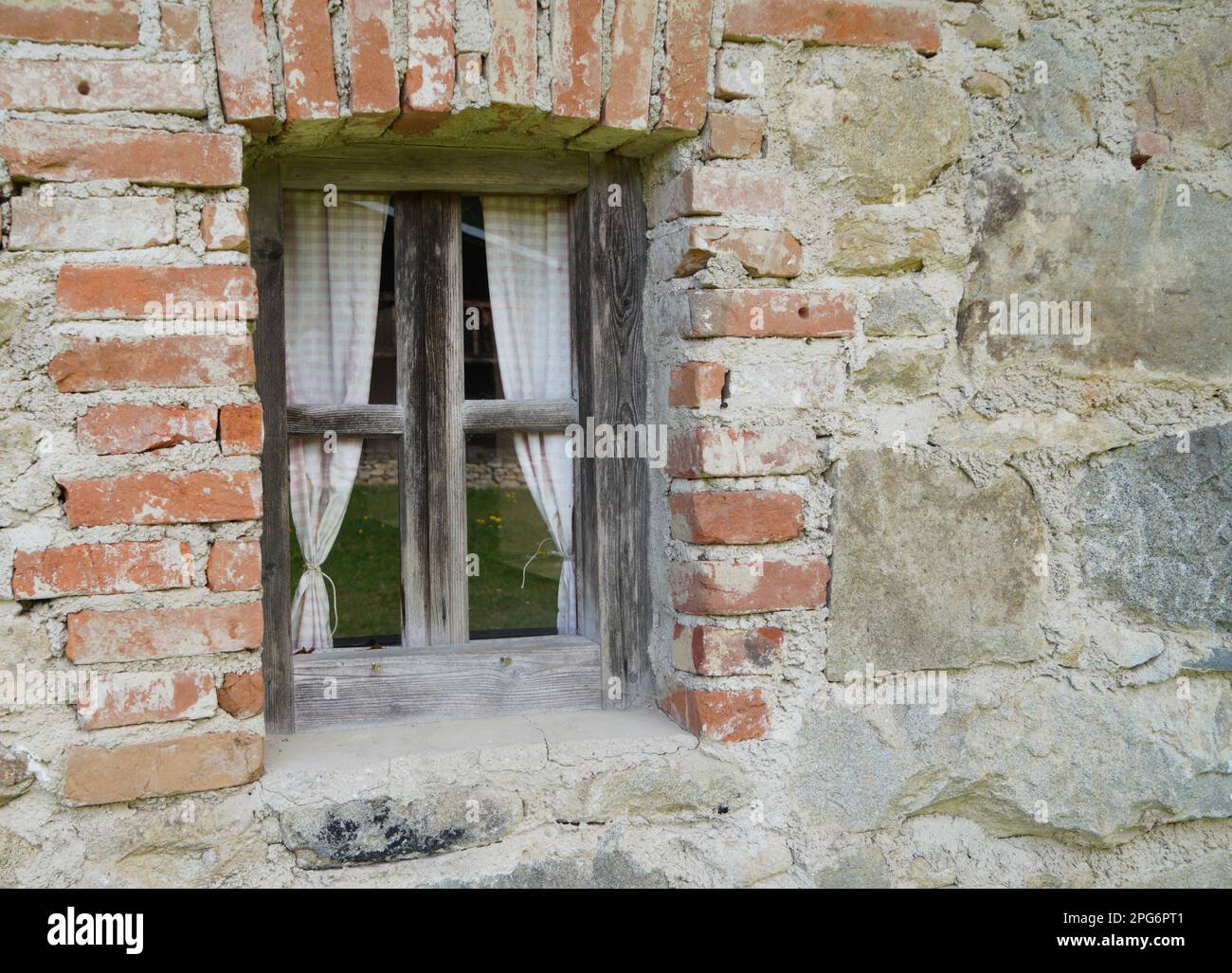 Aged wooden window with glazing and partially weathered in rustic homes ...